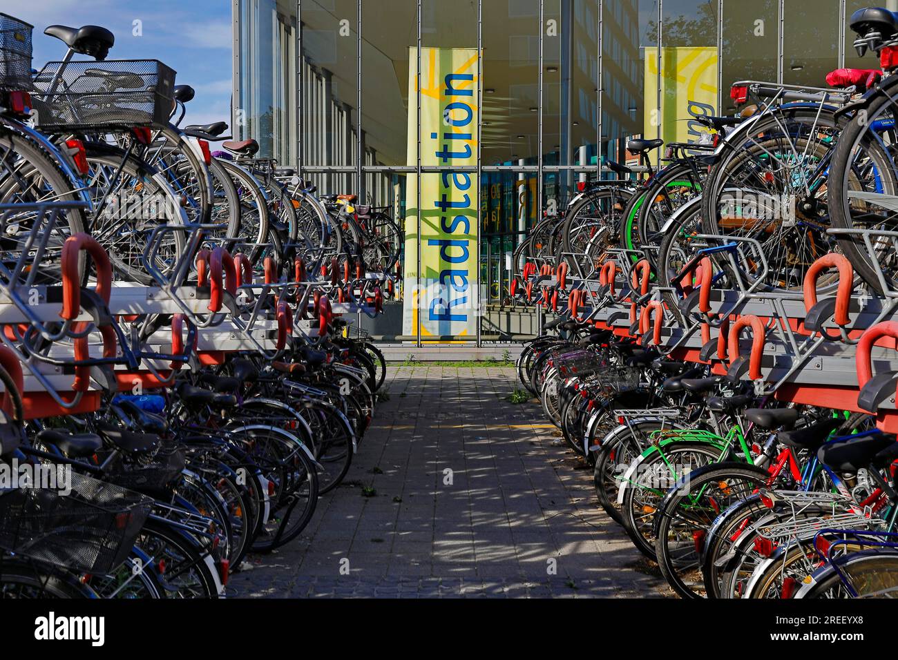 Very many bicycles in the parking spaces of the bike station at the ...