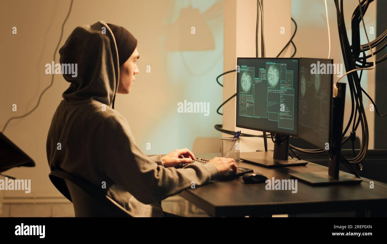 Young hacker enjoying cybercrime achievement at night, breaking into ...
