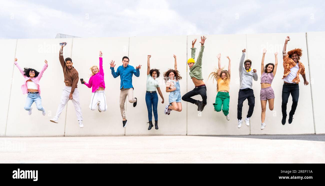 Happy playful multiethnic group of young friends bonding outdoors ...