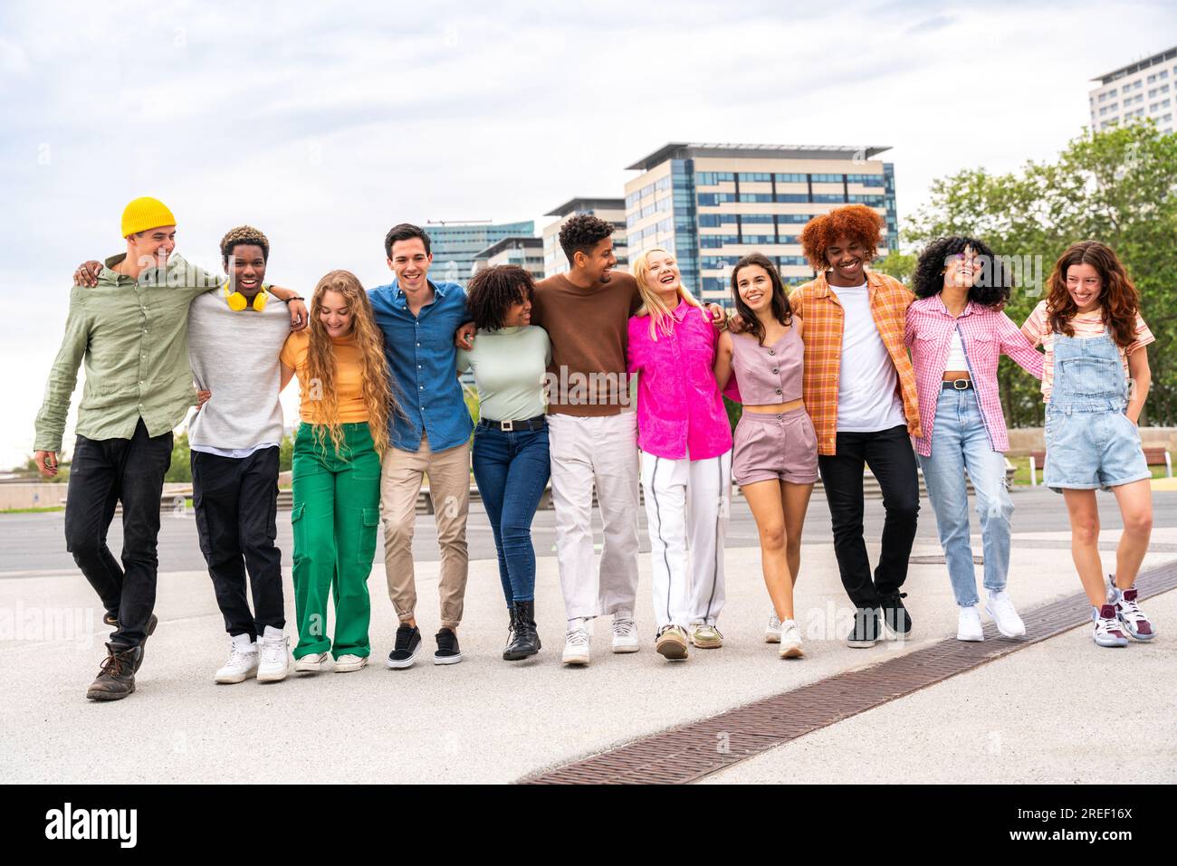 Happy playful multiethnic group of young friends bonding outdoors ...