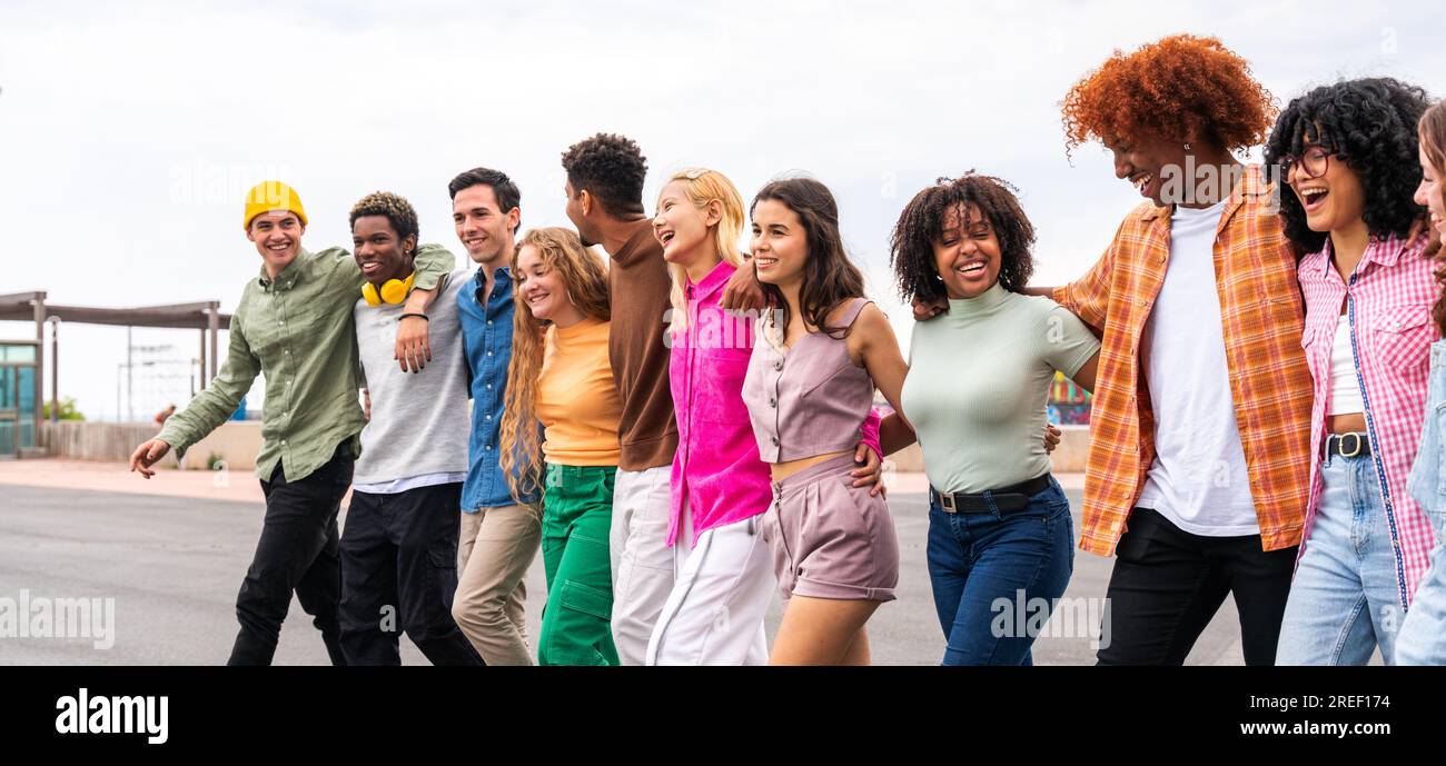 Happy playful multiethnic group of young friends bonding outdoors ...