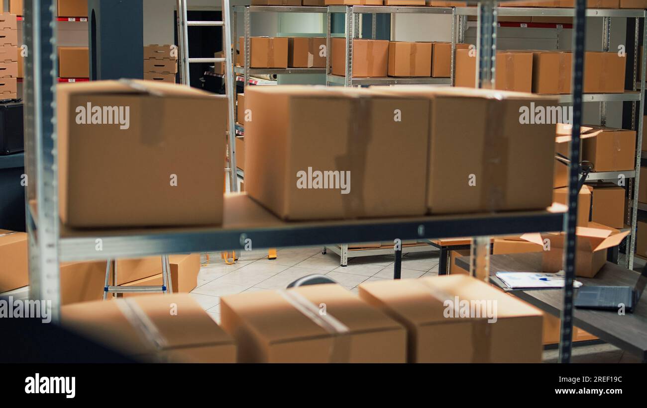 Empty storage room filled with many cardboard boxes on racks, empty ...