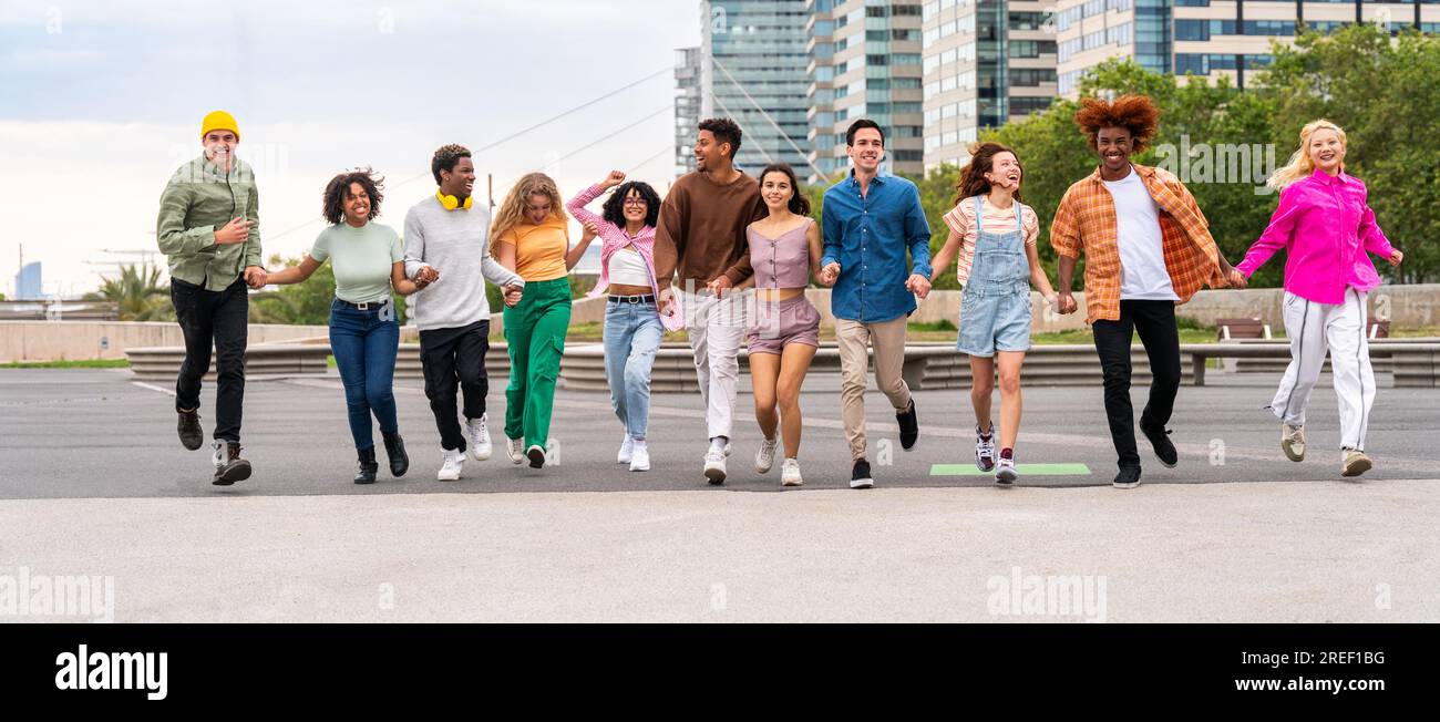 Happy playful multiethnic group of young friends bonding outdoors ...