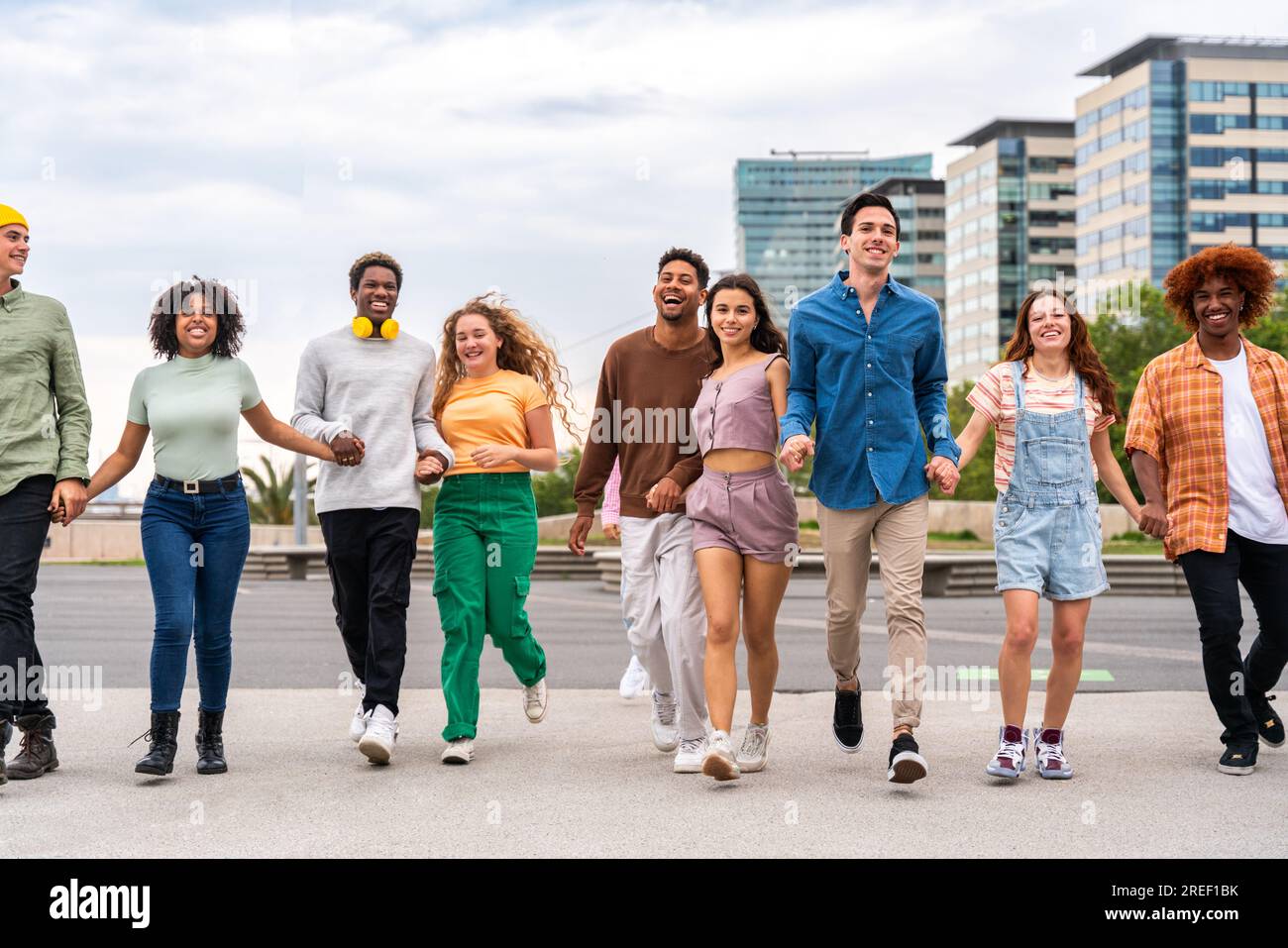 Happy playful multiethnic group of young friends bonding outdoors ...