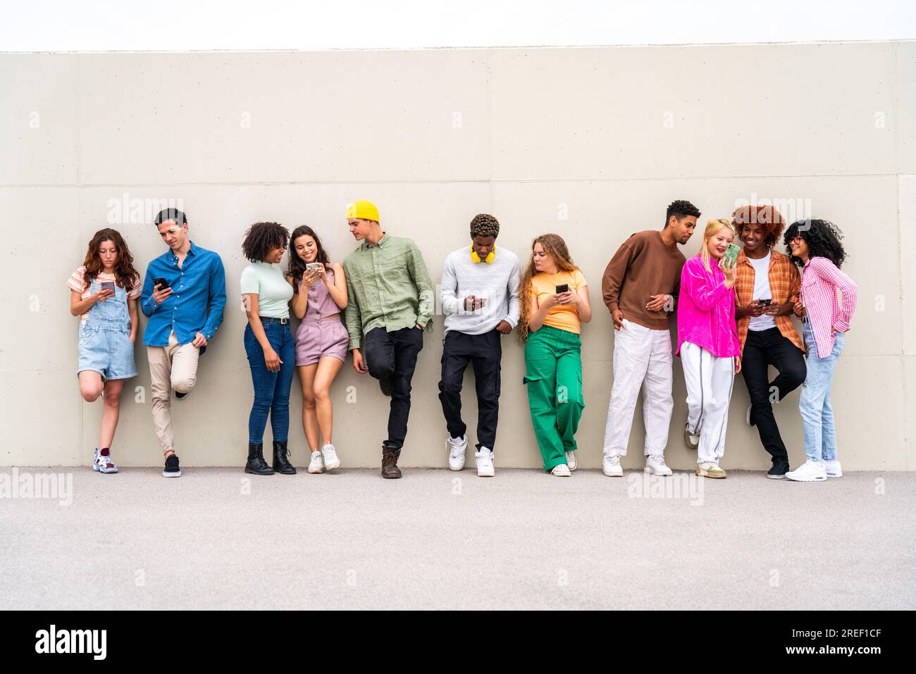 Happy playful multiethnic group of young friends bonding outdoors ...