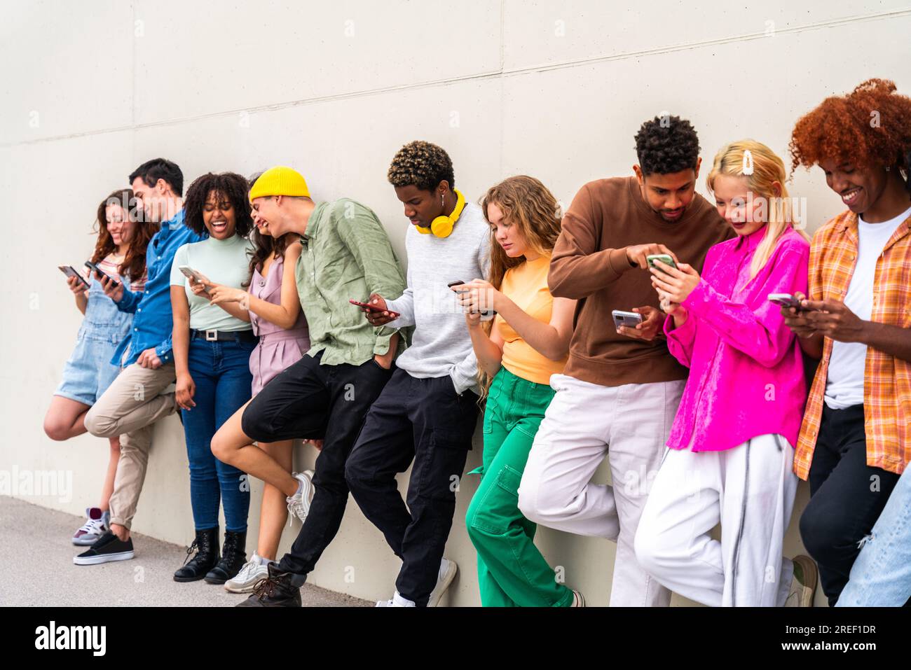 Happy playful multiethnic group of young friends bonding outdoors ...