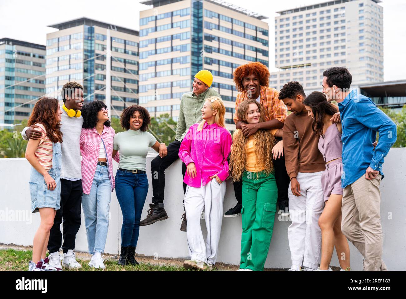 Happy playful multiethnic group of young friends bonding outdoors ...