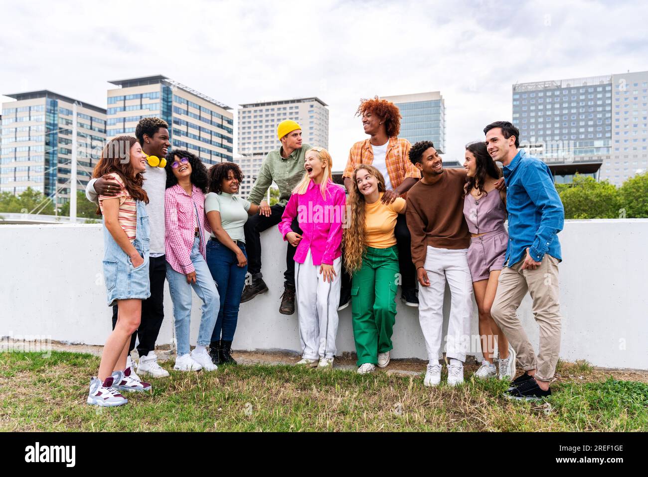 Happy playful multiethnic group of young friends bonding outdoors ...