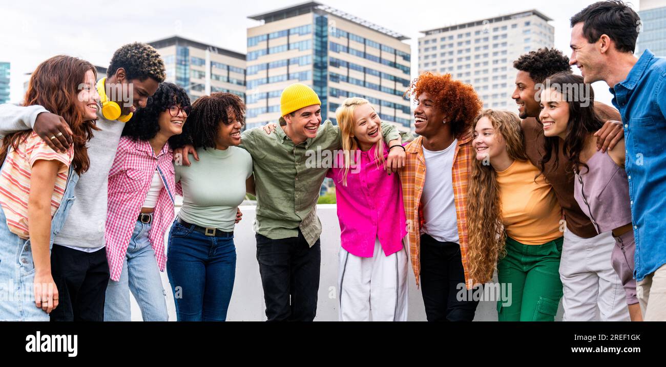 Happy playful multiethnic group of young friends bonding outdoors ...