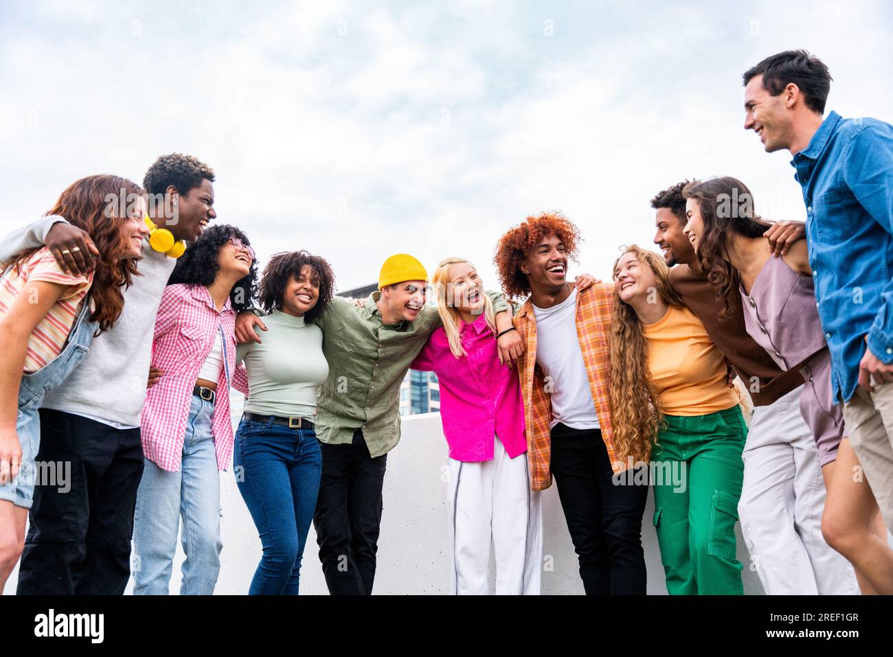 Happy playful multiethnic group of young friends bonding outdoors ...