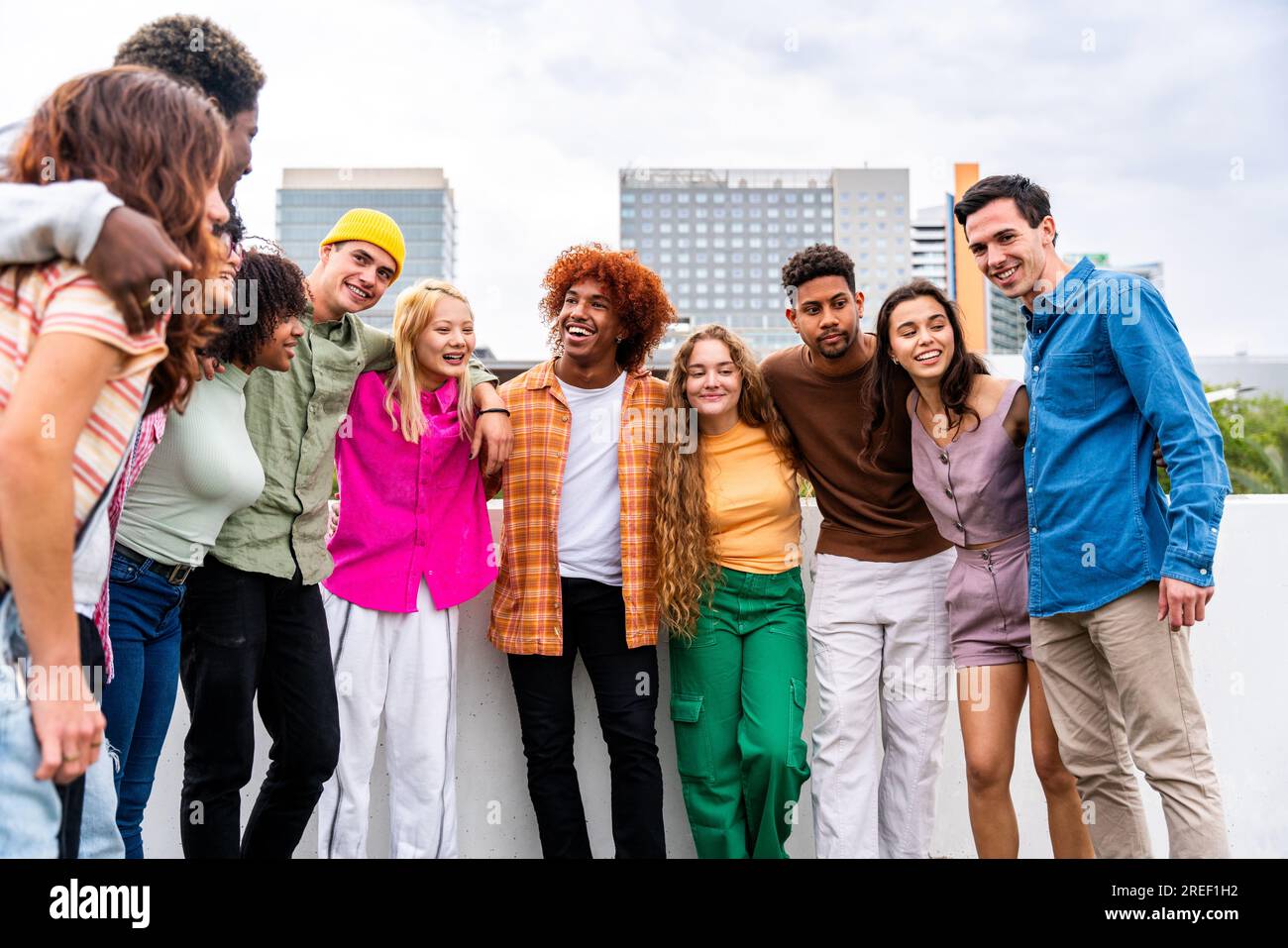 Happy playful multiethnic group of young friends bonding outdoors ...