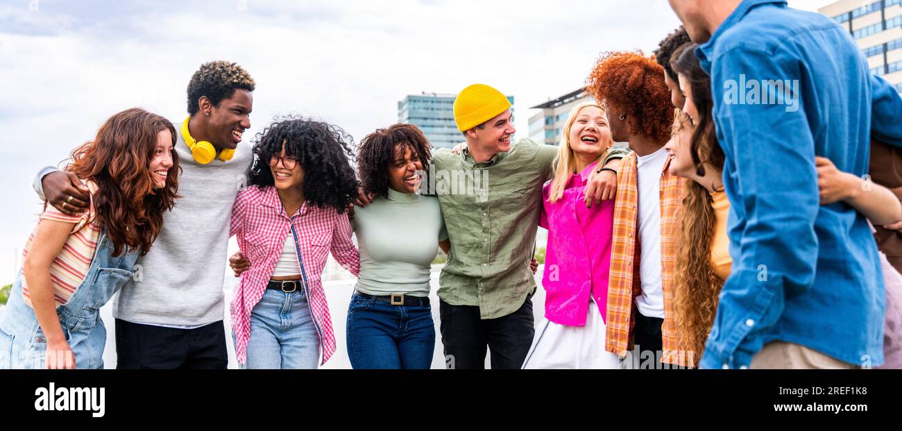 Happy playful multiethnic group of young friends bonding outdoors ...