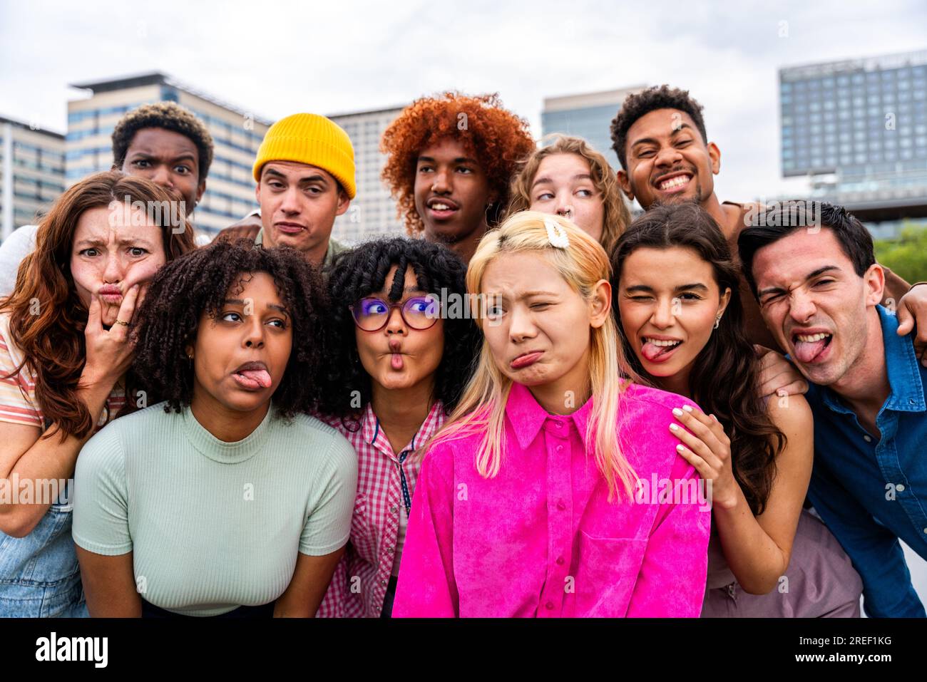 Happy playful multiethnic group of young friends bonding outdoors ...