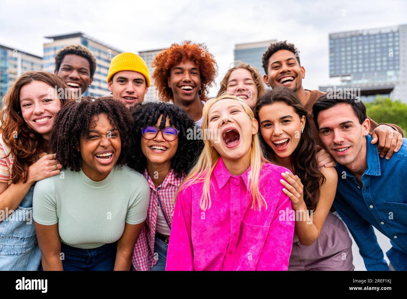Happy playful multiethnic group of young friends bonding outdoors ...