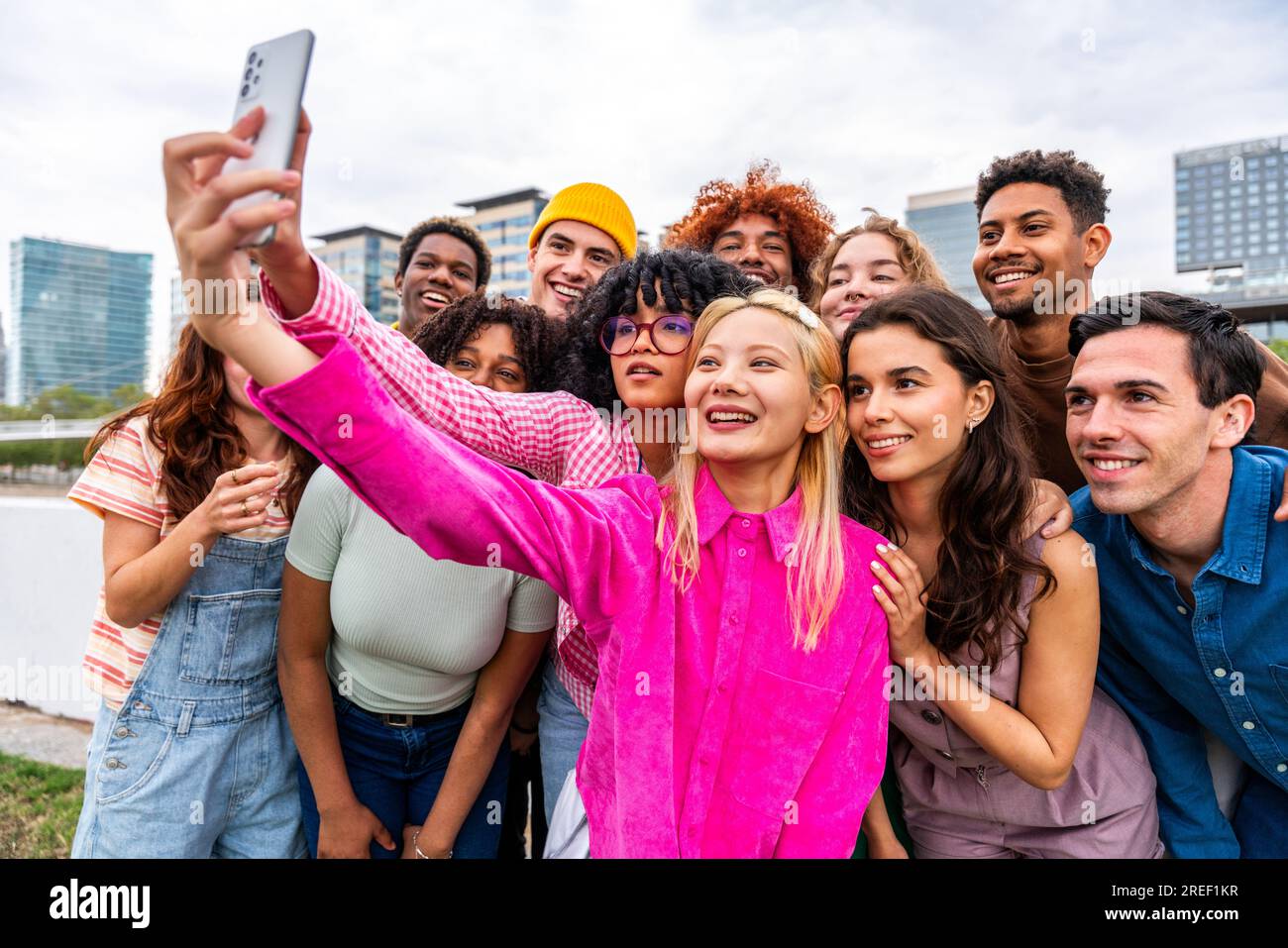 Happy playful multiethnic group of young friends bonding outdoors ...
