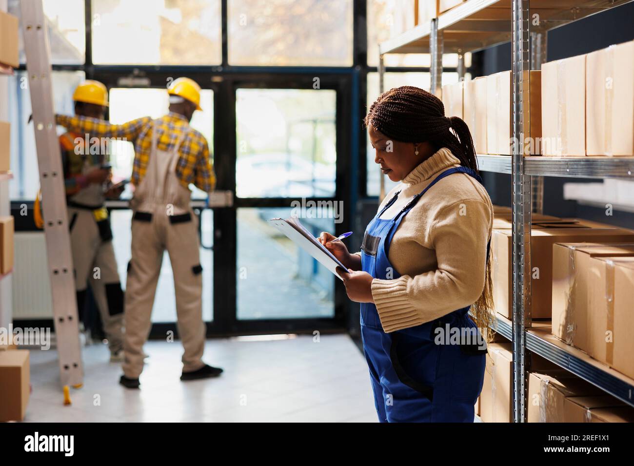 Woman taking inventory in warehouse hi-res stock photography and images ...