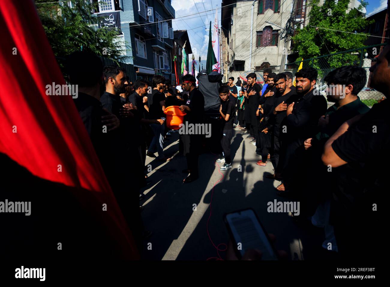 Srinagar, India. 26th July, 2023. Kashmiri Shiite Muslim mourners shout slogans during a ...