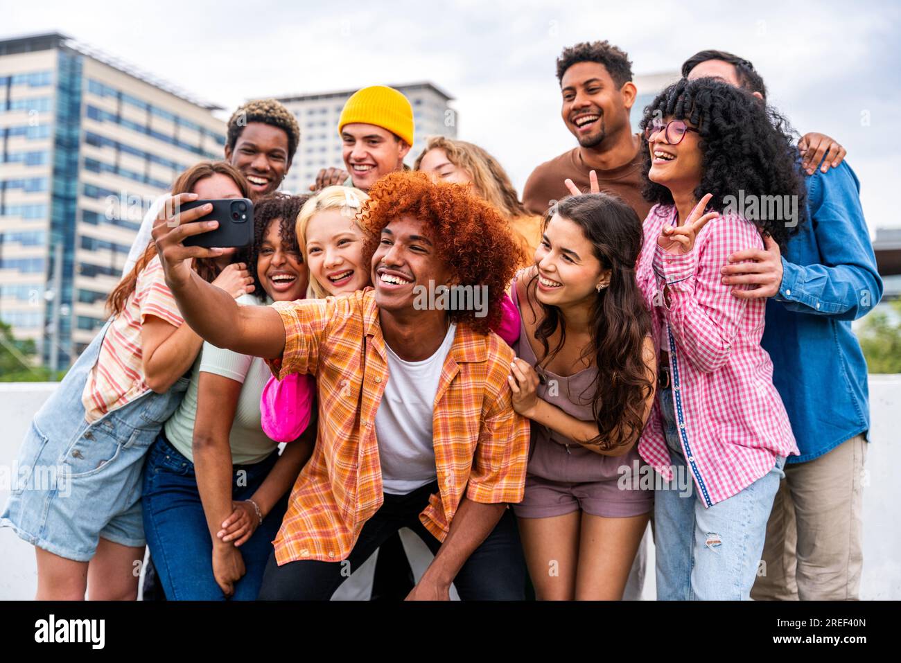 Happy playful multiethnic group of young friends bonding outdoors ...