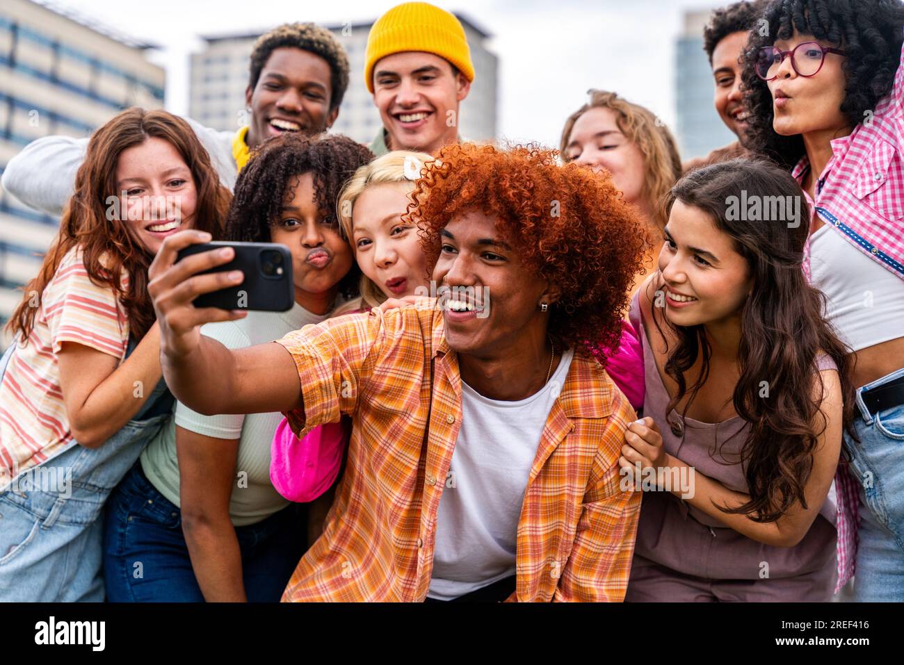 Happy playful multiethnic group of young friends bonding outdoors ...