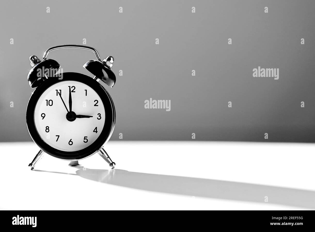 Modern black and white alarm clock in retro style isolated on white and ...