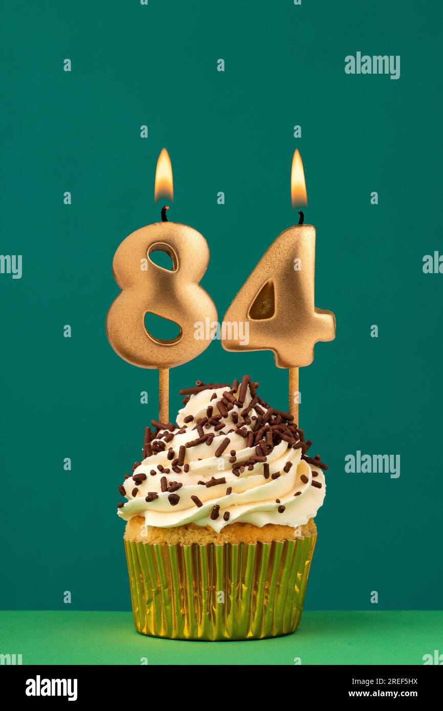 Birthday card with candle number 84 - Green background Stock Photo - Alamy