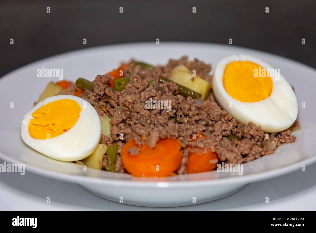 Traditional Tabasco pepper garnishing ground beef dish with vegetables ...