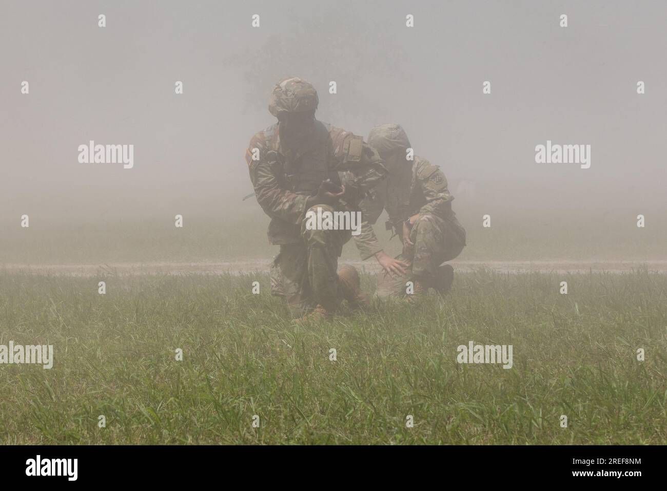 U.S. Army Reserve Soldiers crouch to avoid debris when a CH-53D Sea ...