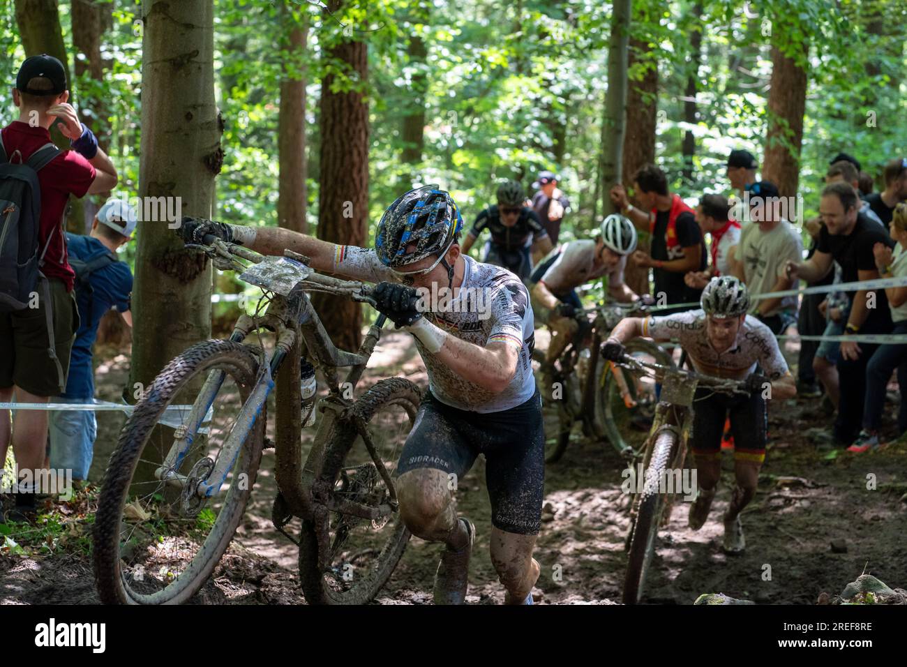 German rider Leon Kaiser pushes bike on muddy steep uphill - 2023 UEC ...