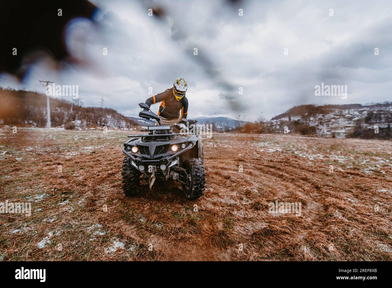 A man is fearlessly enjoying an adventurous ride on an ATV Quad through ...