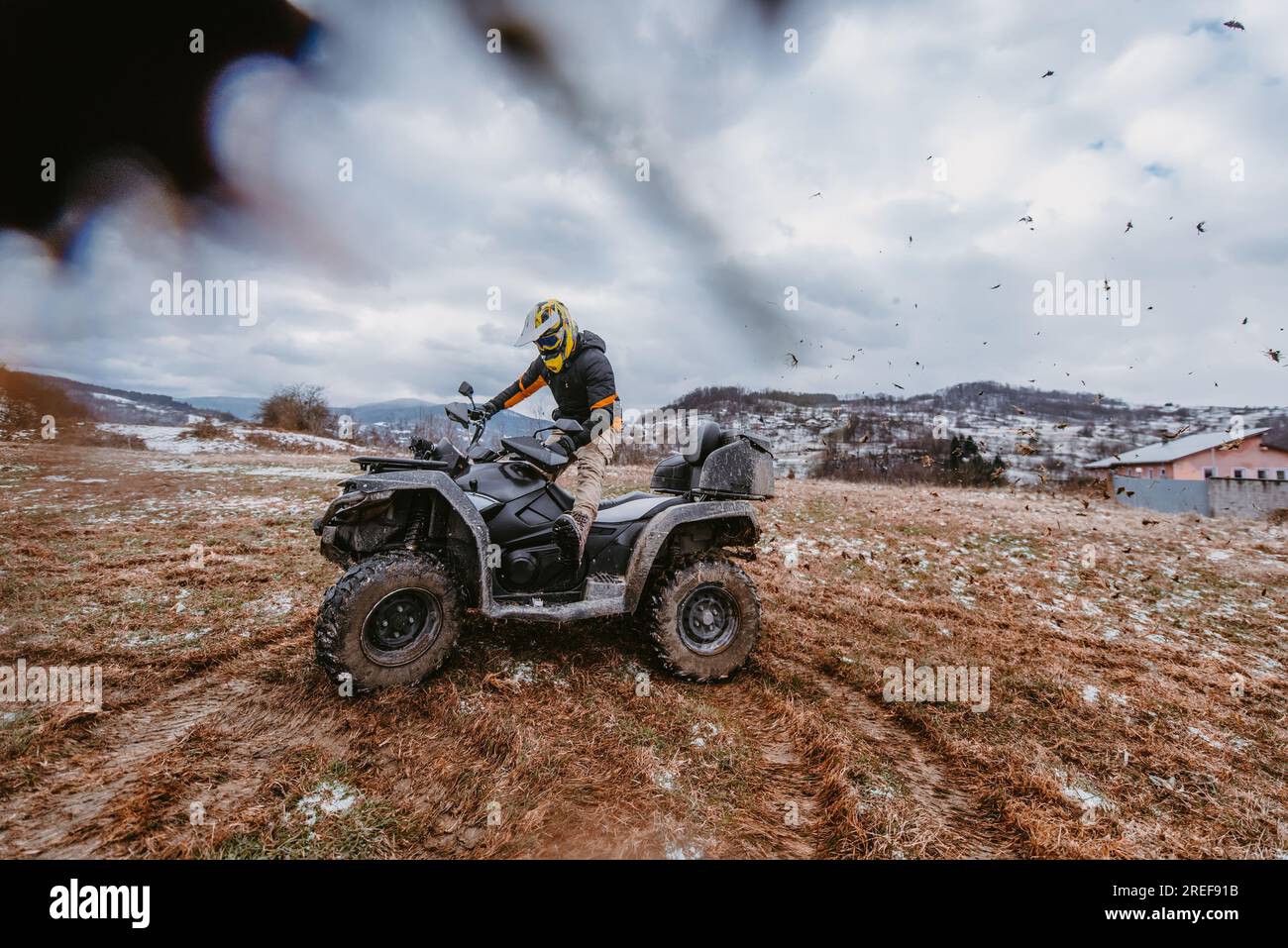 A man is fearlessly enjoying an adventurous ride on an ATV Quad through ...
