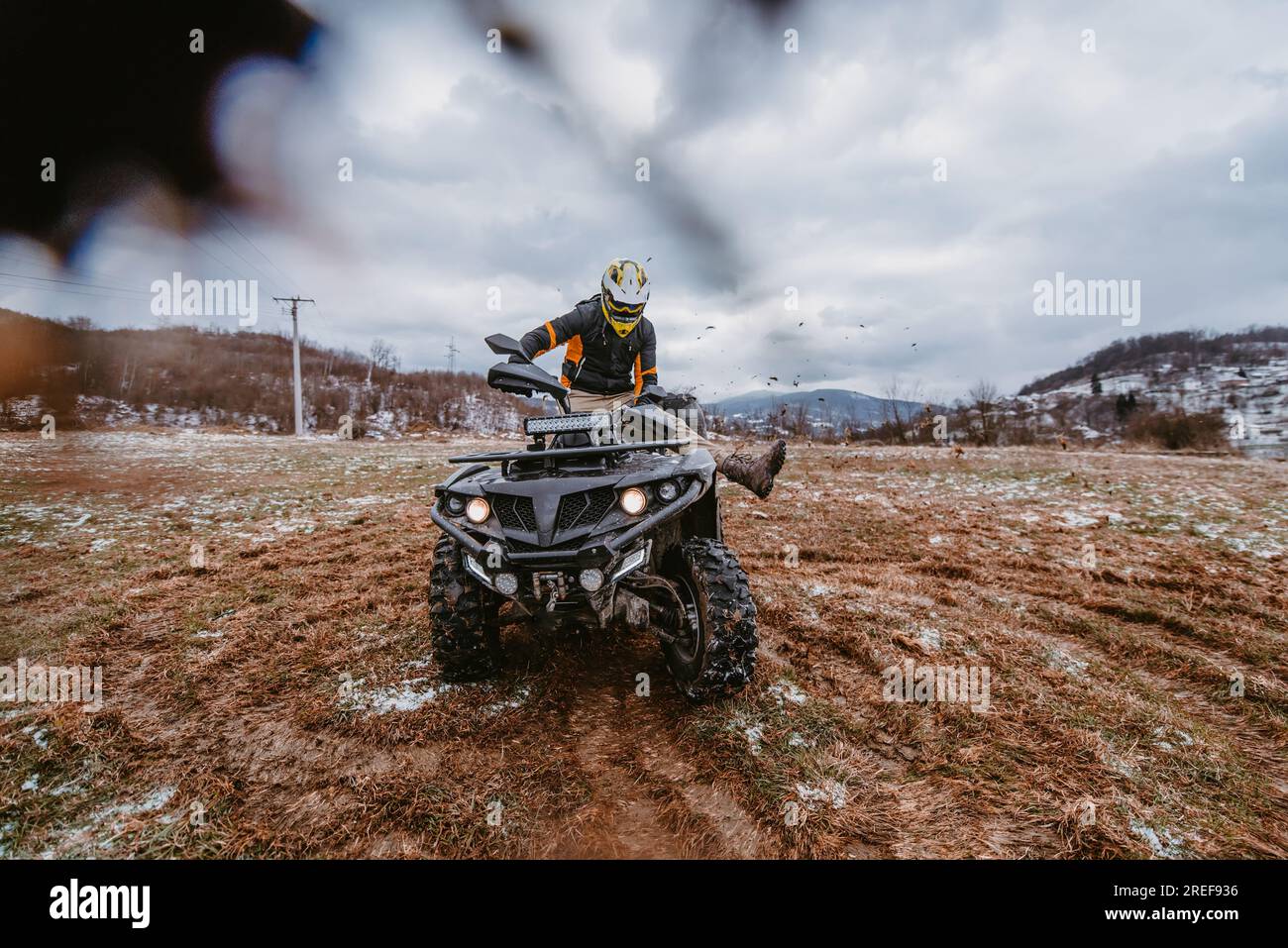 A man is fearlessly enjoying an adventurous ride on an ATV Quad through ...