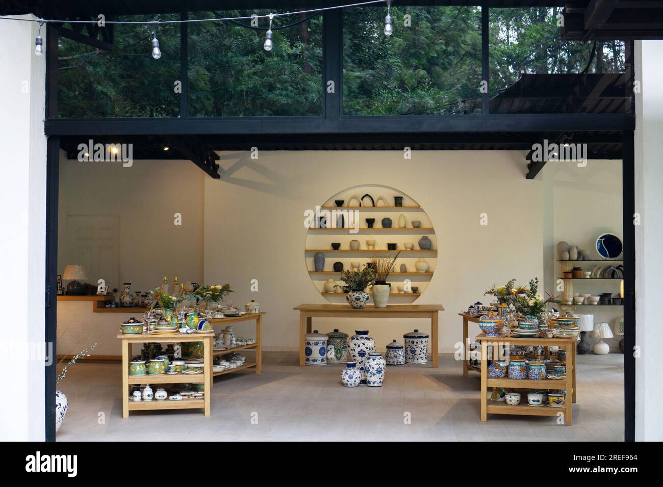 Inside store with retail sale of ceramic and porcelain pots, planters ...