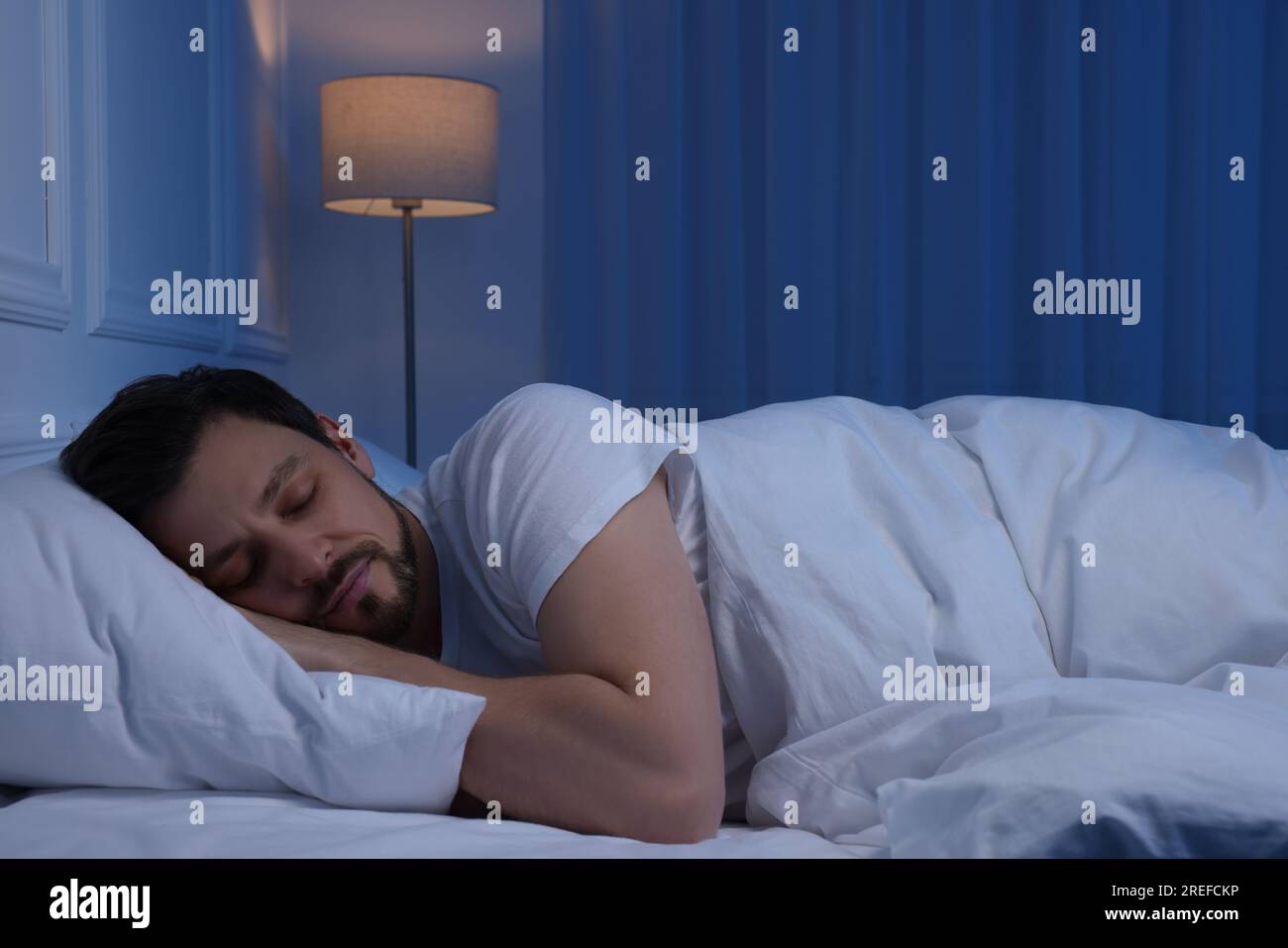 Handsome man sleeping in bed at night Stock Photo - Alamy