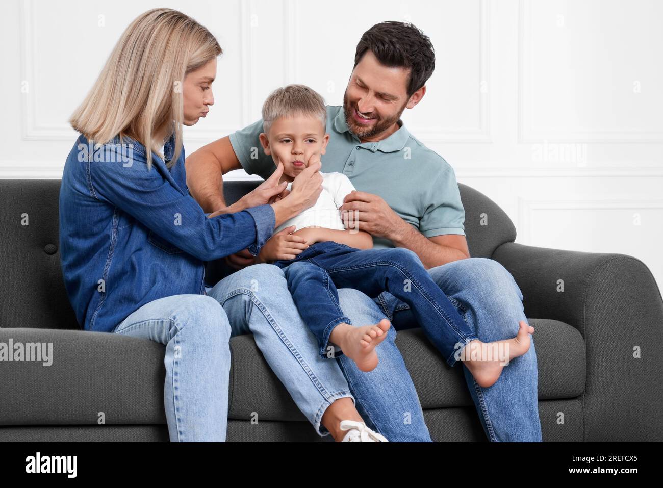 Happy family having fun together on sofa at home Stock Photo - Alamy