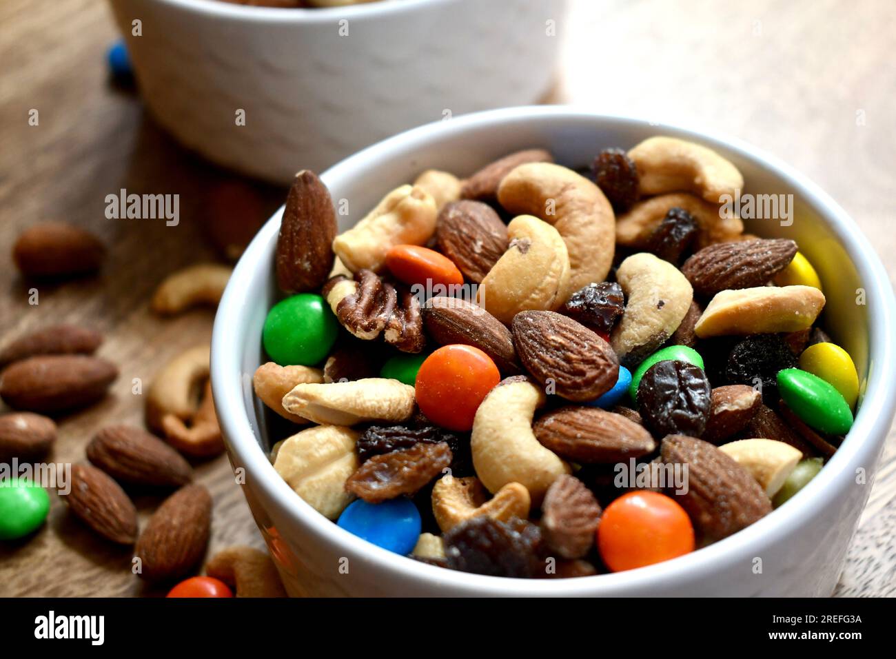 Colorful trail mix in a white bowl Stock Photo - Alamy