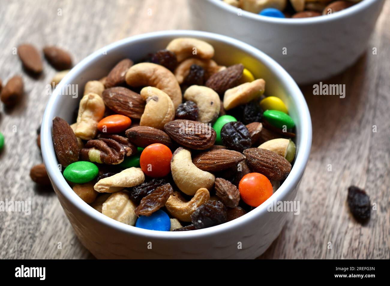 Colorful trail mix in a white bowl Stock Photo - Alamy