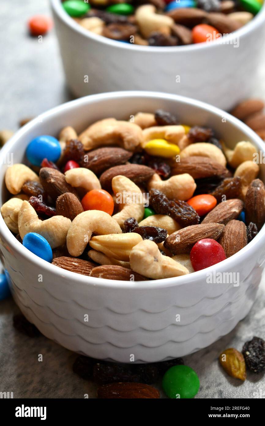 Colorful trail mix in a white bowl Stock Photo - Alamy
