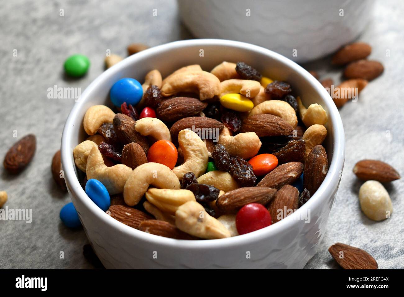 Colorful trail mix in a white bowl Stock Photo - Alamy