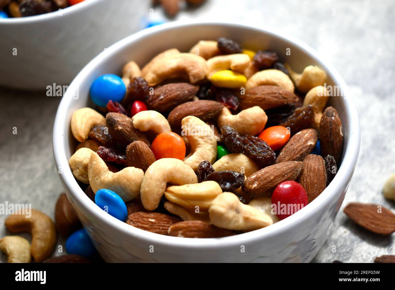 Colorful trail mix in a white bowl Stock Photo - Alamy