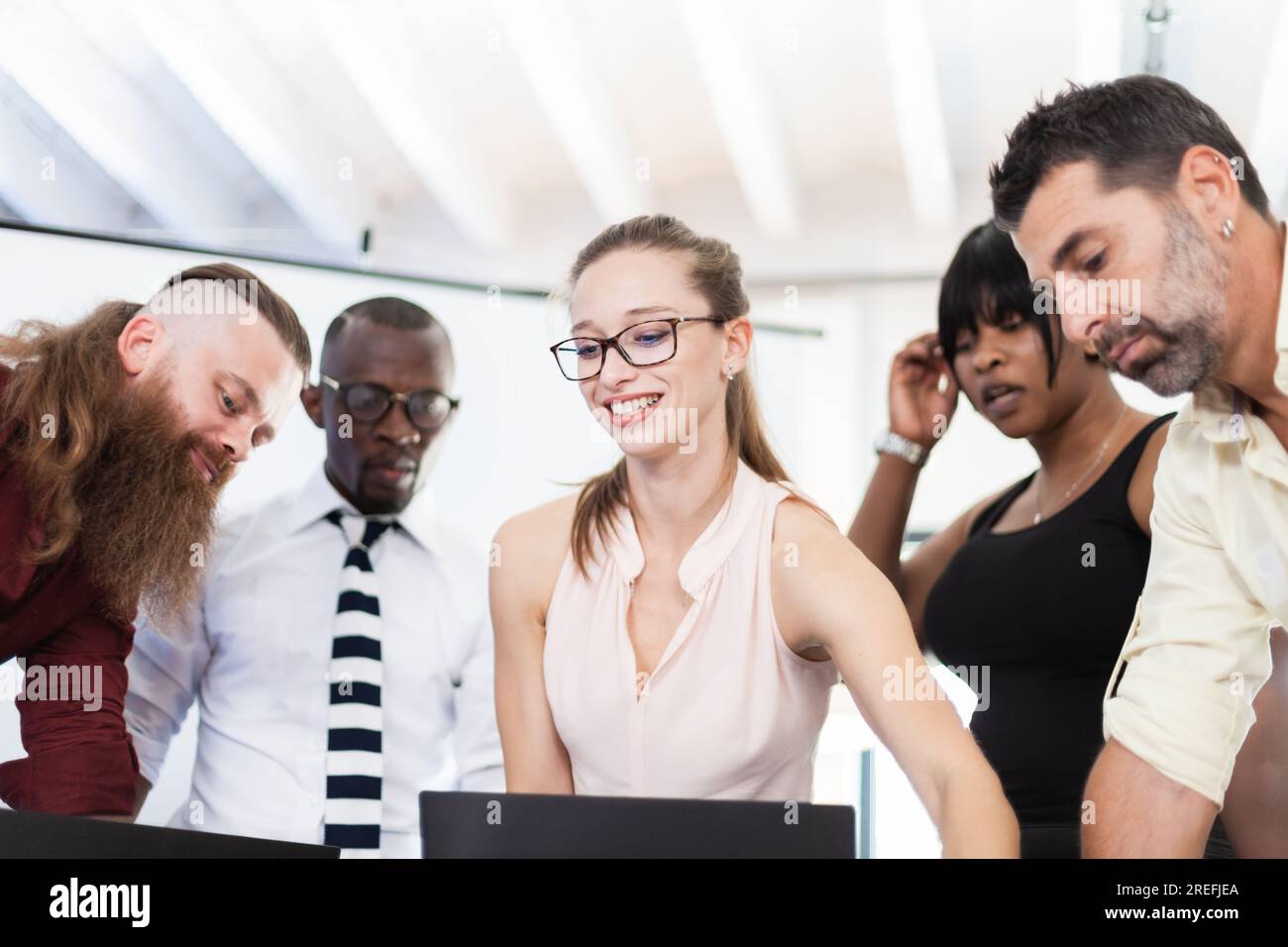 Multiracial business people working together at boardroom table at office. Successful team of ...