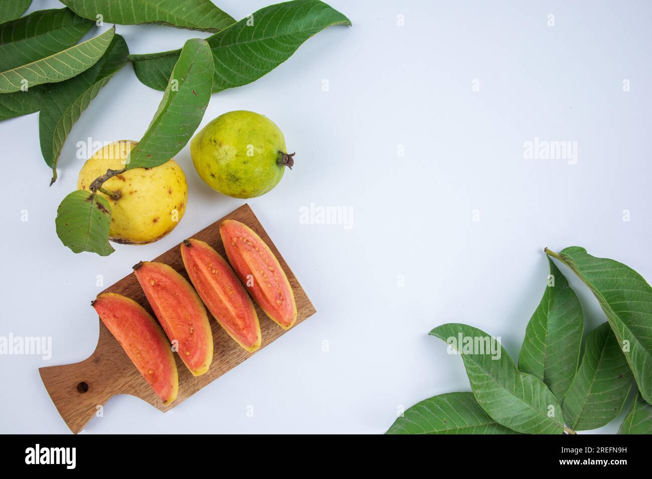fresh guava slices with green leaves on white background Stock Photo ...