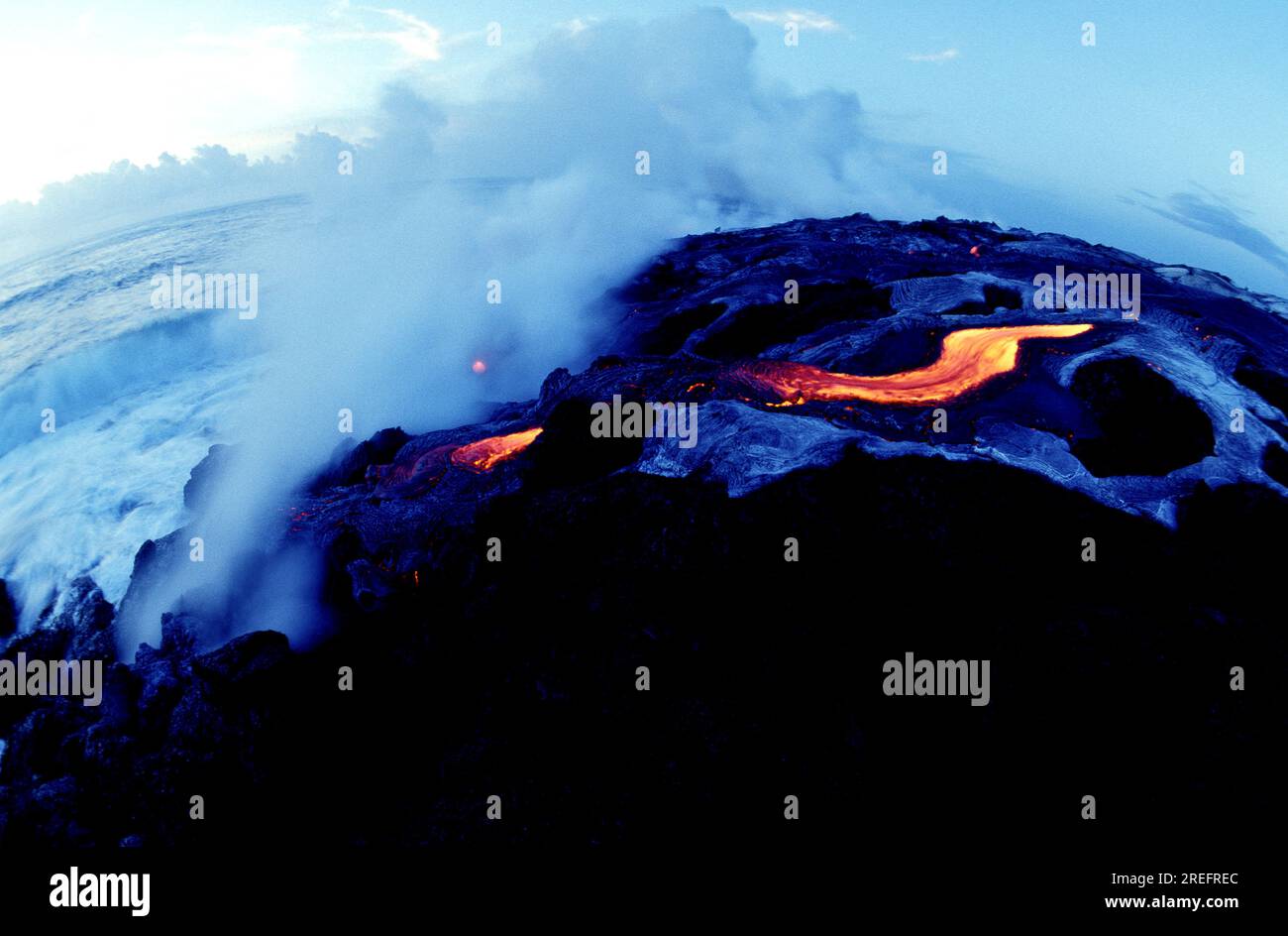 Lava enters the ocean creating an explosion of steam at Volcanoes ...