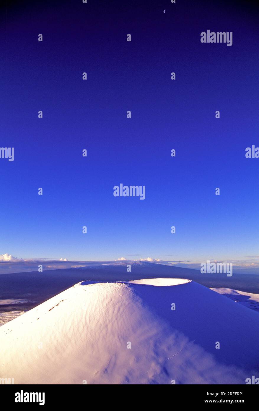 A volcanic cindercone covered with snow on top of Mauna Kea on the Big ...