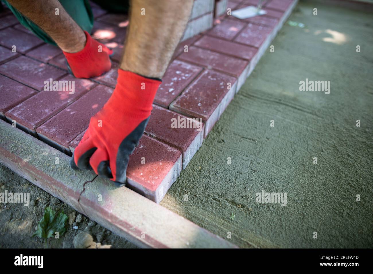 Paving work for laying a new pedestrian path is being done in the ...