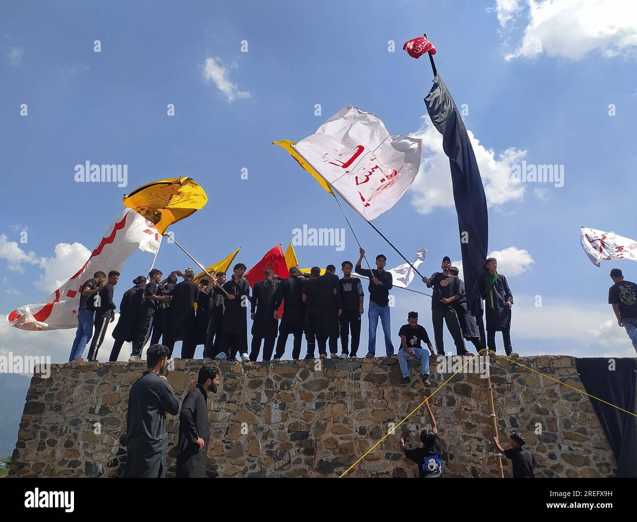 Shia muslims unfurling flags during muharram Procession Stock Photo - Alamy
