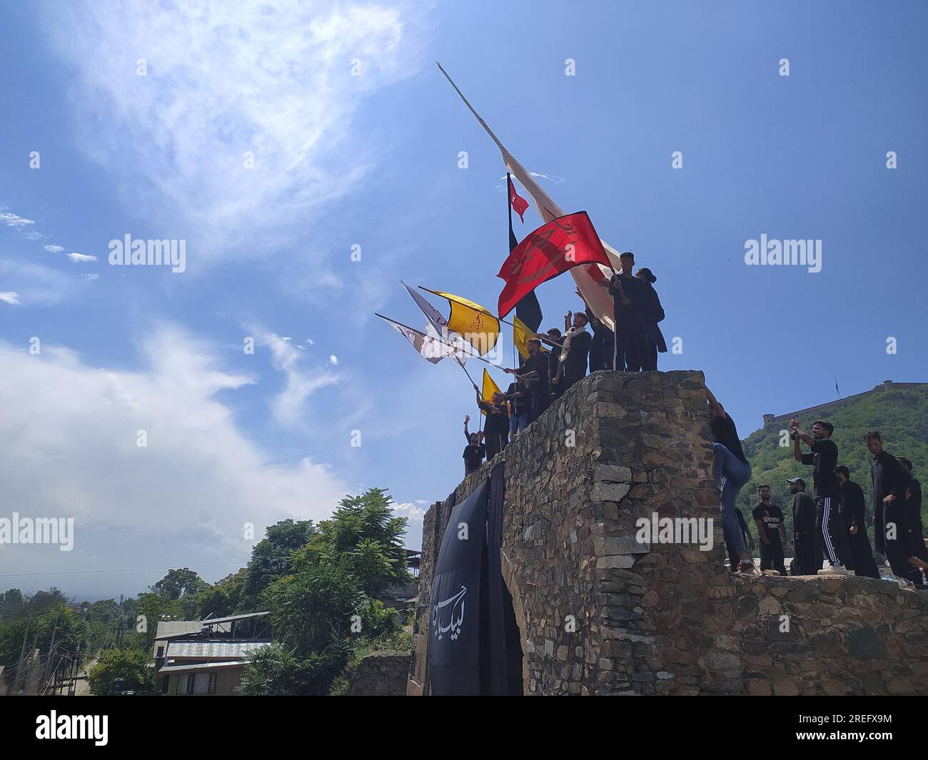 Shia muslims unfurling flags during muharram Procession Stock Photo - Alamy