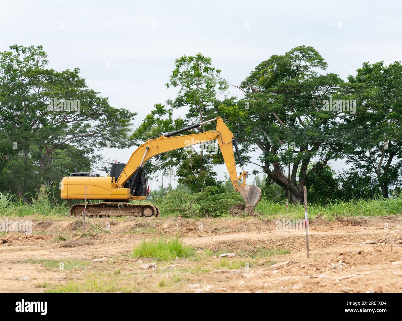 Excuvator adjusting ground level in construction site Stock Photo - Alamy