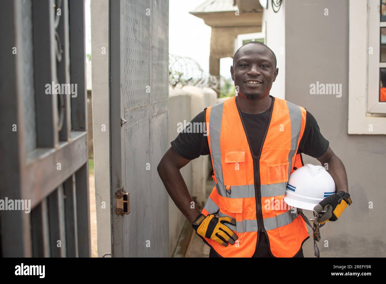 portrait of young african engineer holding his helmet Stock Photo - Alamy