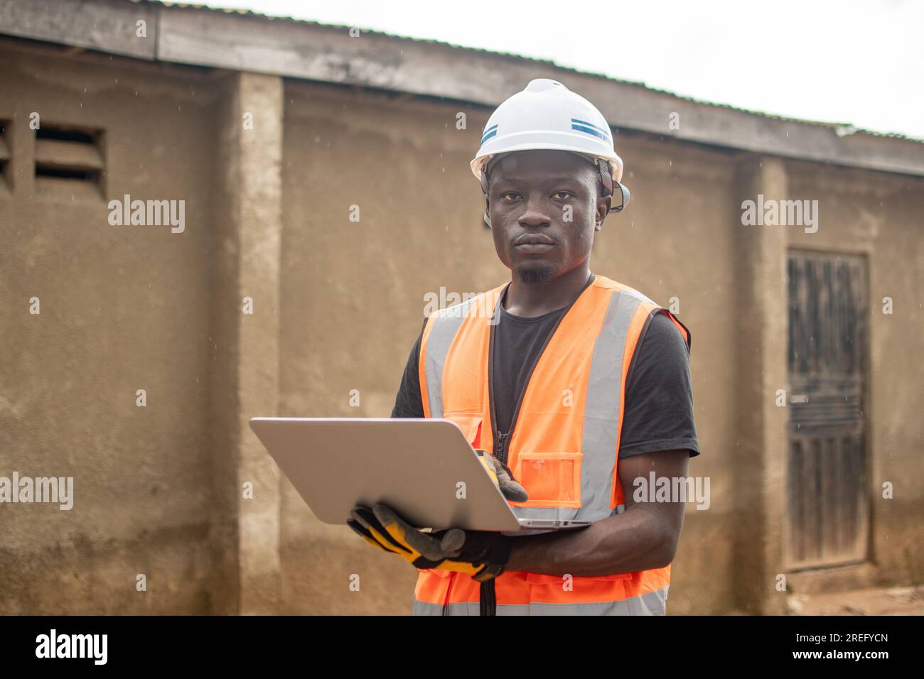 Engineer wearing helmet holding laptop hi-res stock photography and ...