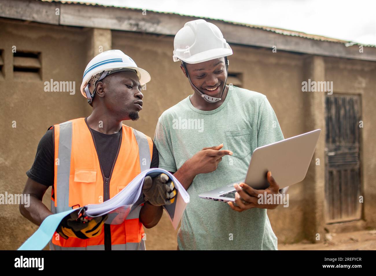 two african engineers working using a laptop Stock Photo - Alamy